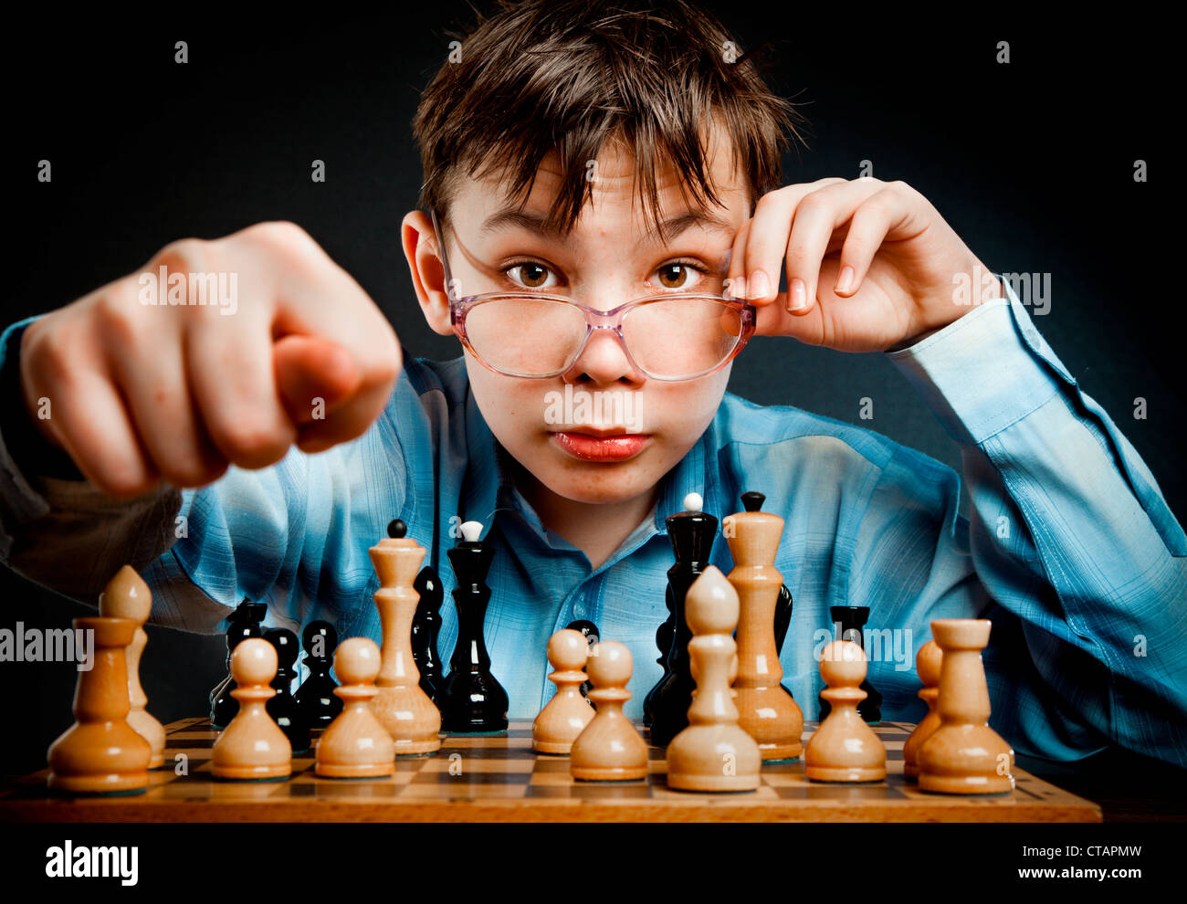 Nerd play chess on a black background Stock Photo - Alamy