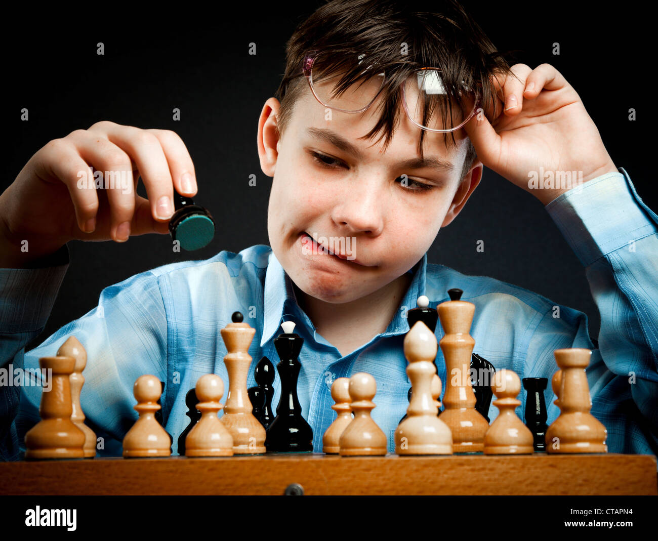 Nerd play chess on a black background Stock Photo - Alamy
