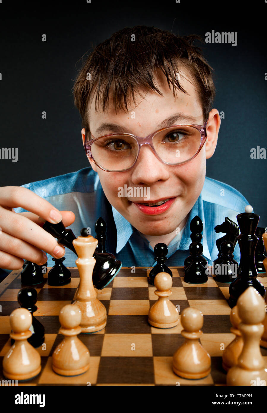 Nerd play chess on a black background Stock Photo - Alamy