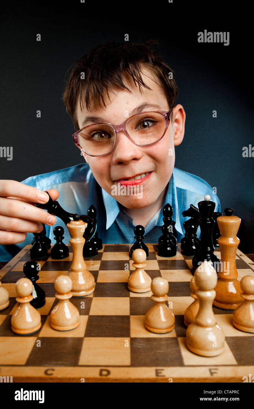 Nerd play chess on a black background Stock Photo - Alamy