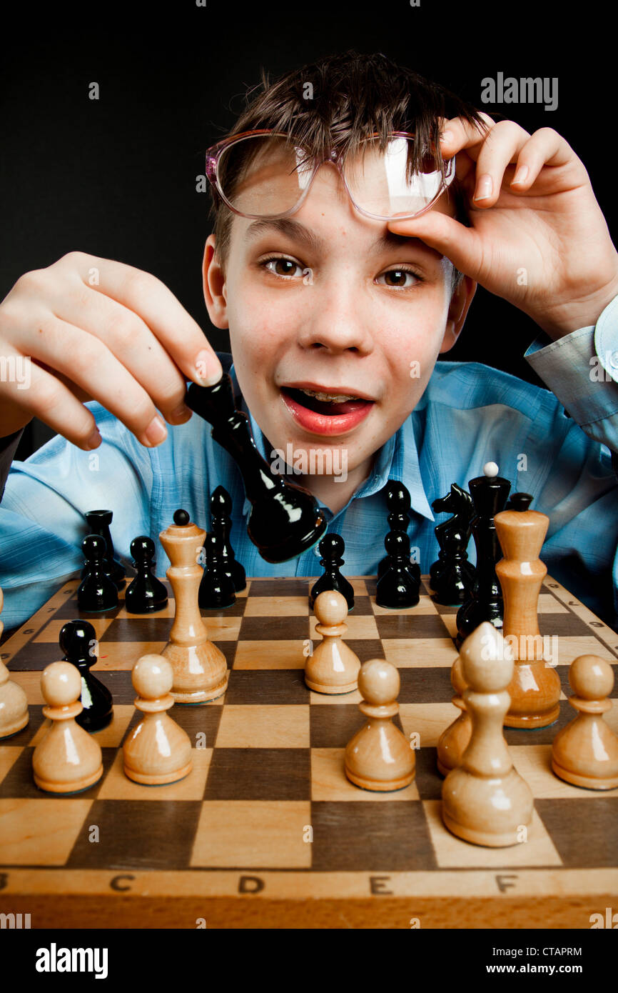 Nerd play chess on a black background Stock Photo - Alamy