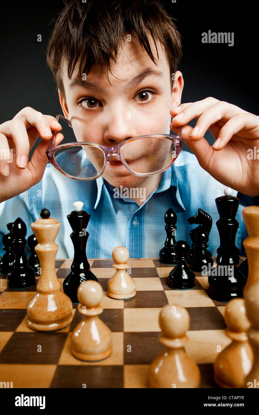 Nerd play chess on a black background Stock Photo - Alamy