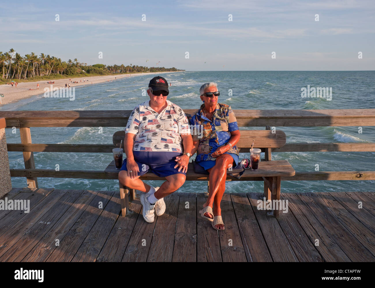 Elderly man and woman enjoying the sunset from the Naples Florida ...