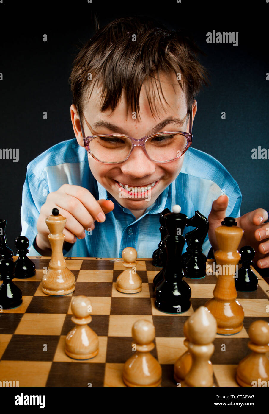 Nerd play chess on a black background Stock Photo - Alamy