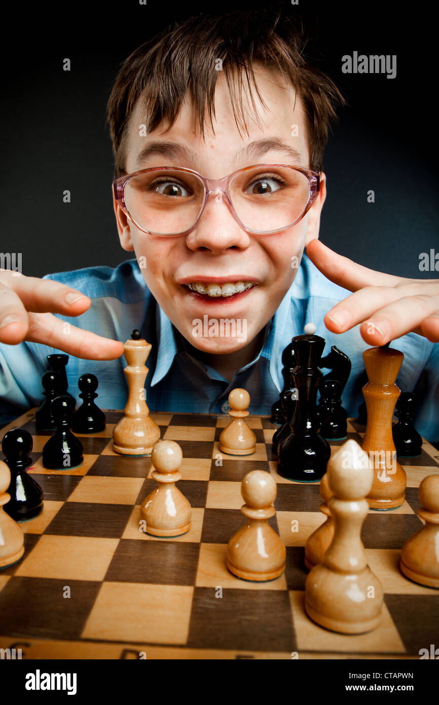 Nerd play chess on a black background Stock Photo - Alamy