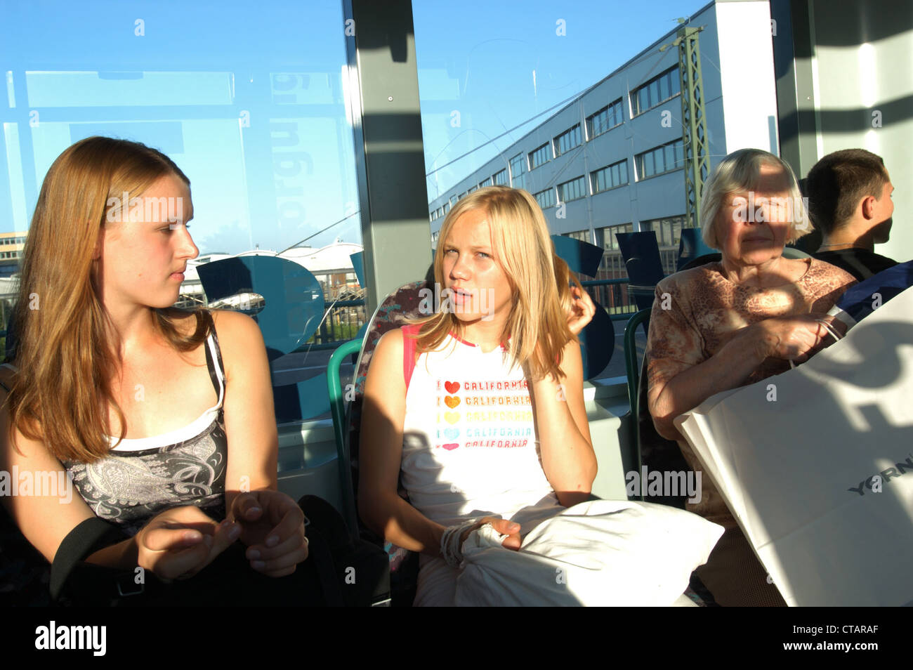 Girls and old lady in the tram Stock Photo - Alamy