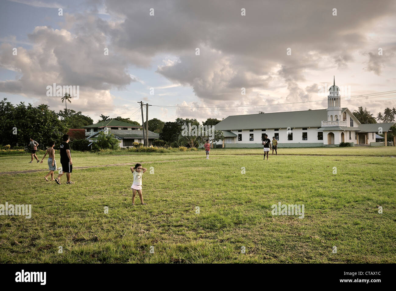 Locals play rugby in front of a church, typical village lifestyle, Apia ...