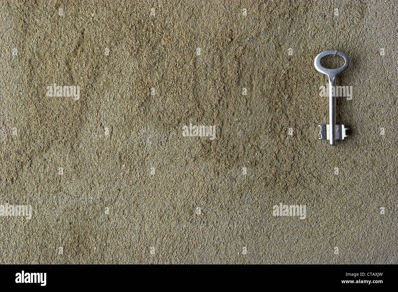 Iron key on a concrete wall Stock Photo - Alamy