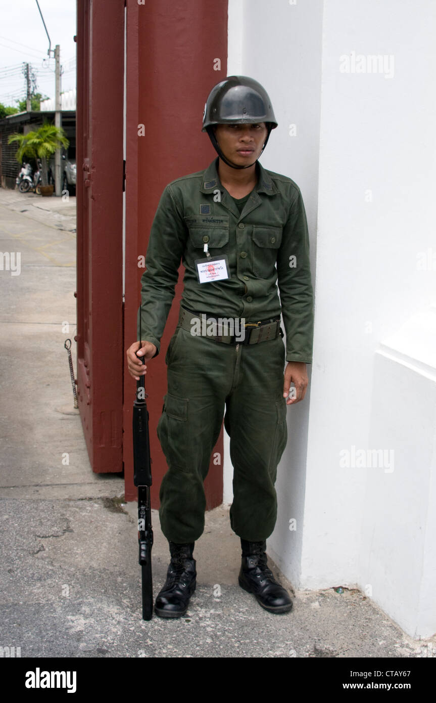 A sentry of the Thai Army stands guard at the gates of the Grand Palace ...