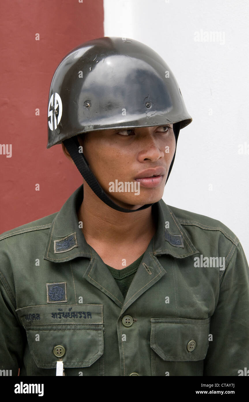 A sentry of the Thai Army stands guard at the gates of the Grand Palace ...