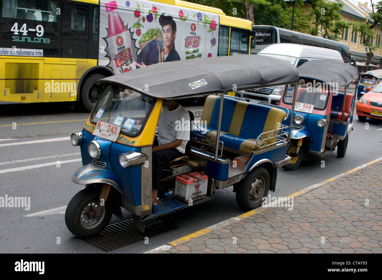 A couple or Tut-tuts queue up touting for business from visiting ...