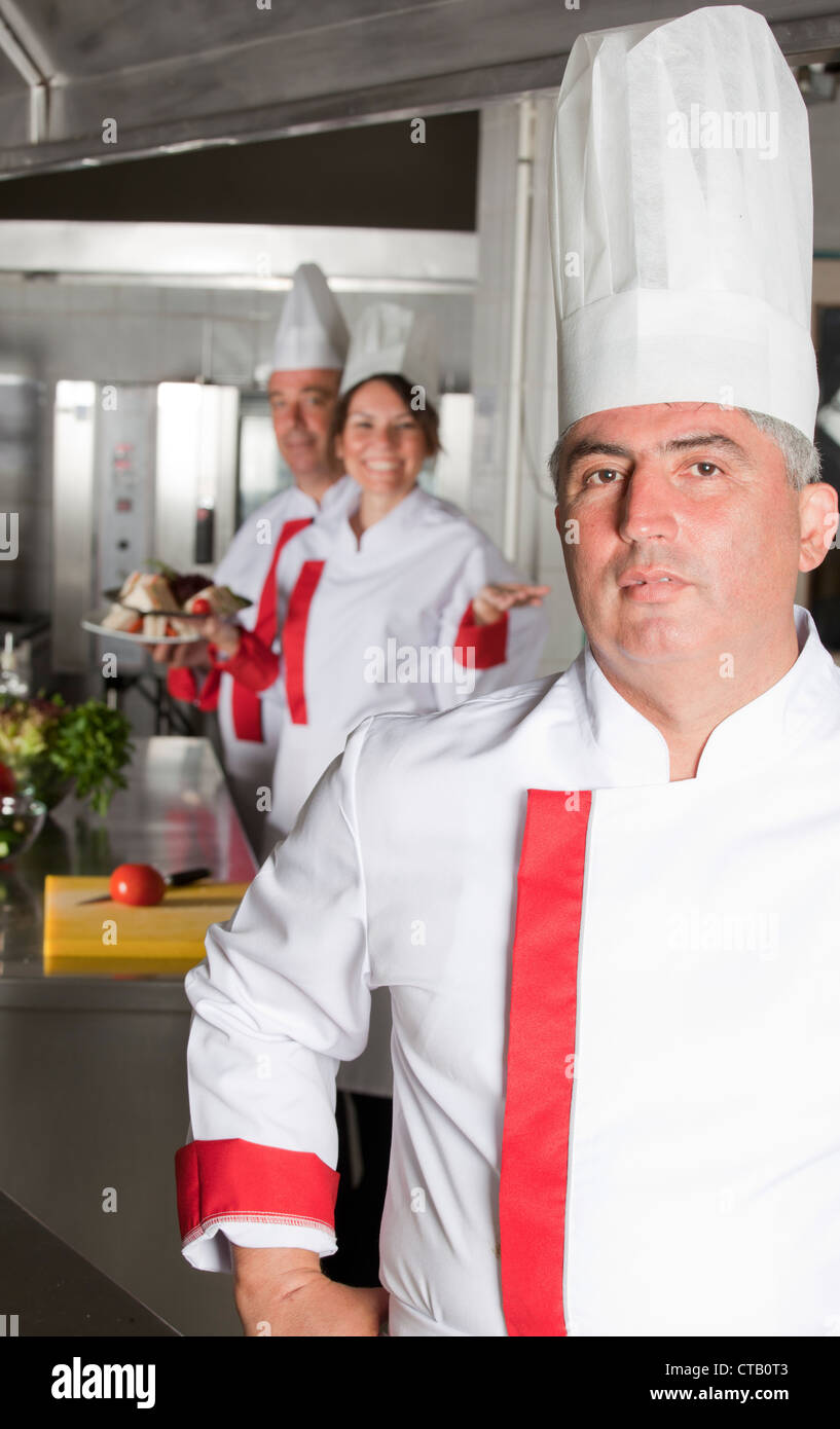 group of young beautiful professional chefs portrait in industrial ...