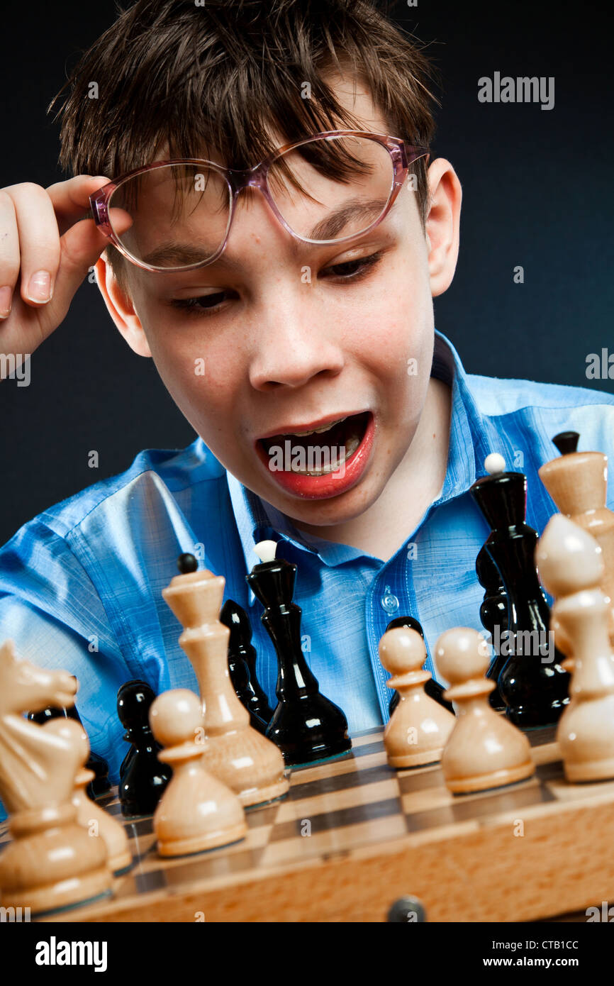 Nerd play chess on a black background Stock Photo - Alamy