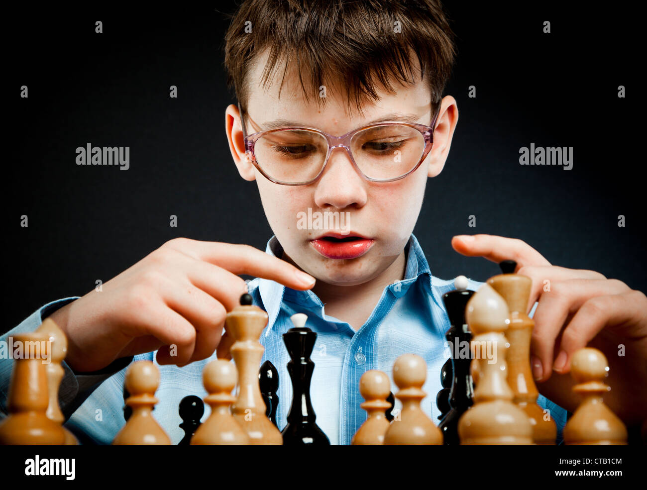Nerd play chess on a black background Stock Photo - Alamy