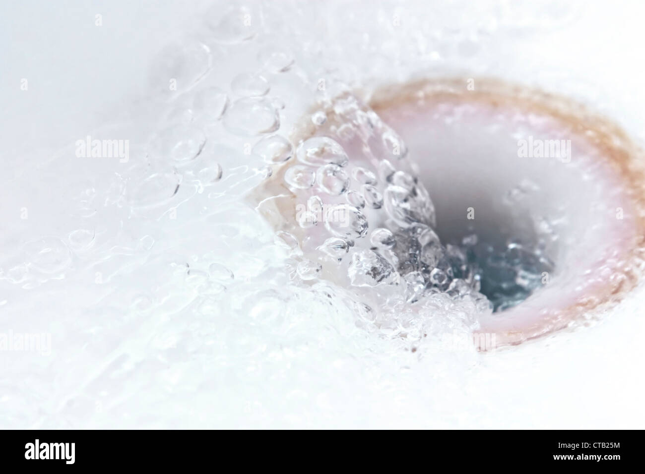 turbulent bubbly flow of water in the sink closeup Stock Photo - Alamy