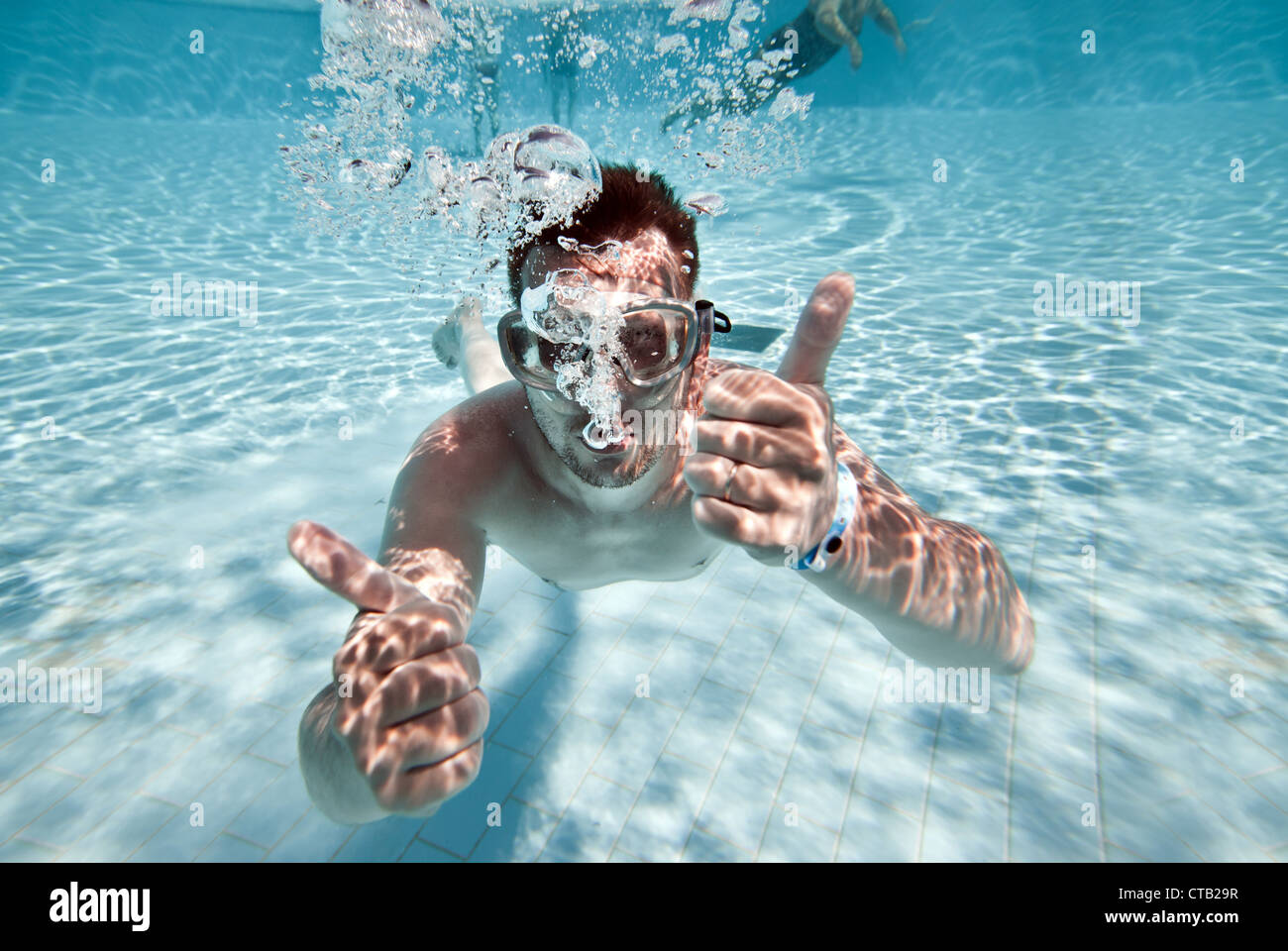 man floats underwater in pool Stock Photo - Alamy