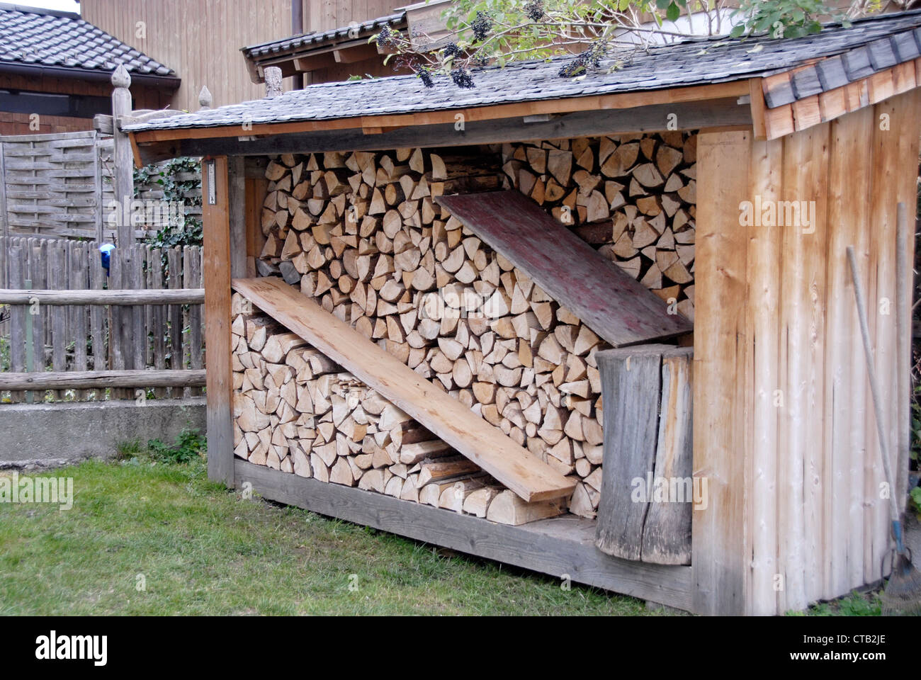 Wood pile shed on side of house in Mittenwald, a German municipality in ...