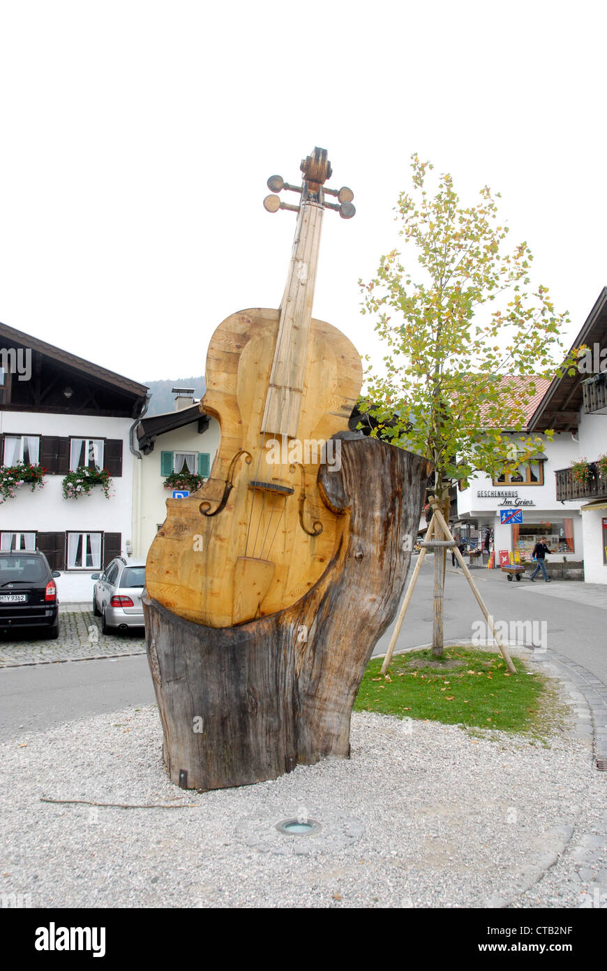 Violin carved in tree stump in Mittenwald, a German municipality in the ...