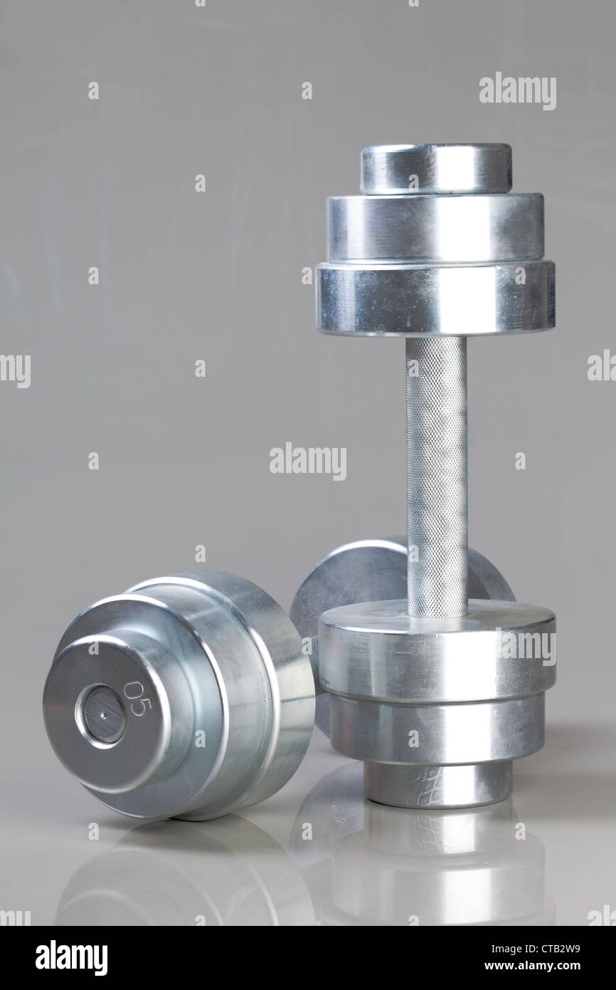Photo dumbbells on a grey background Stock Photo - Alamy