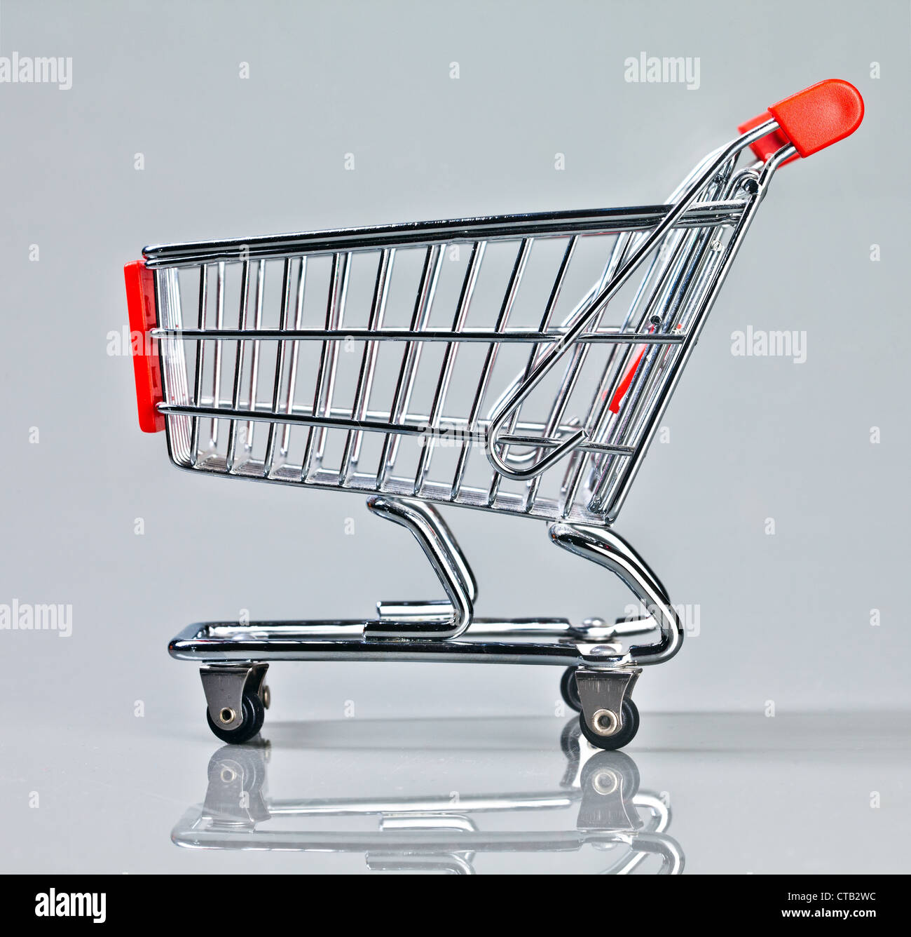 shopping cart on a grey background Stock Photo - Alamy