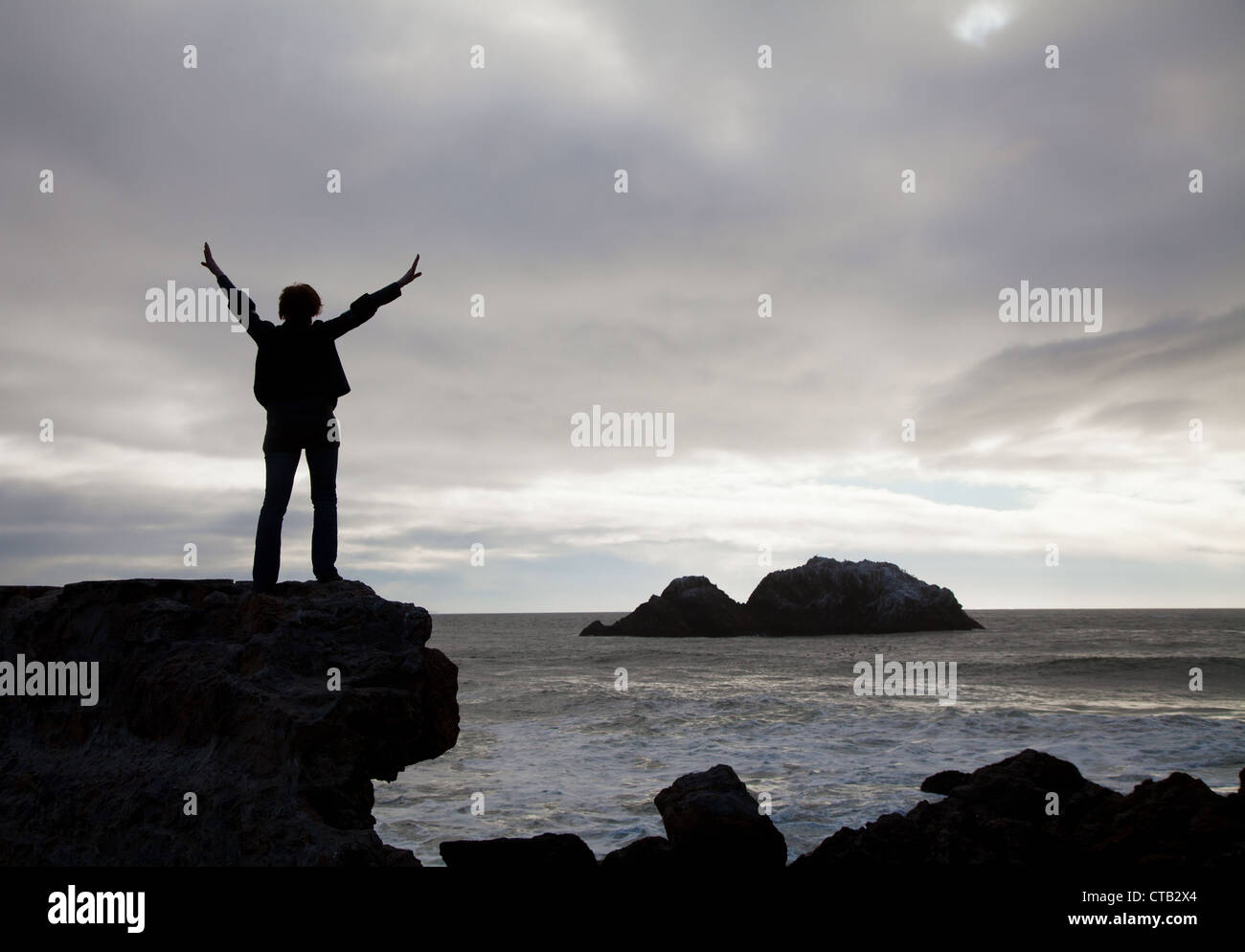Silhouette woman arms raised against hi-res stock photography and ...