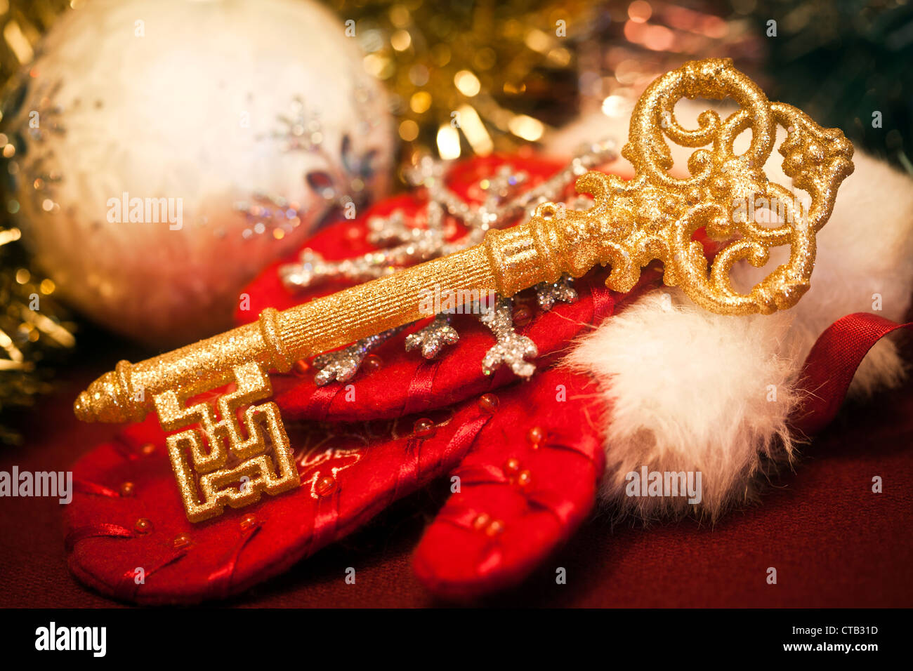 Gold key against Christmas toys Stock Photo - Alamy
