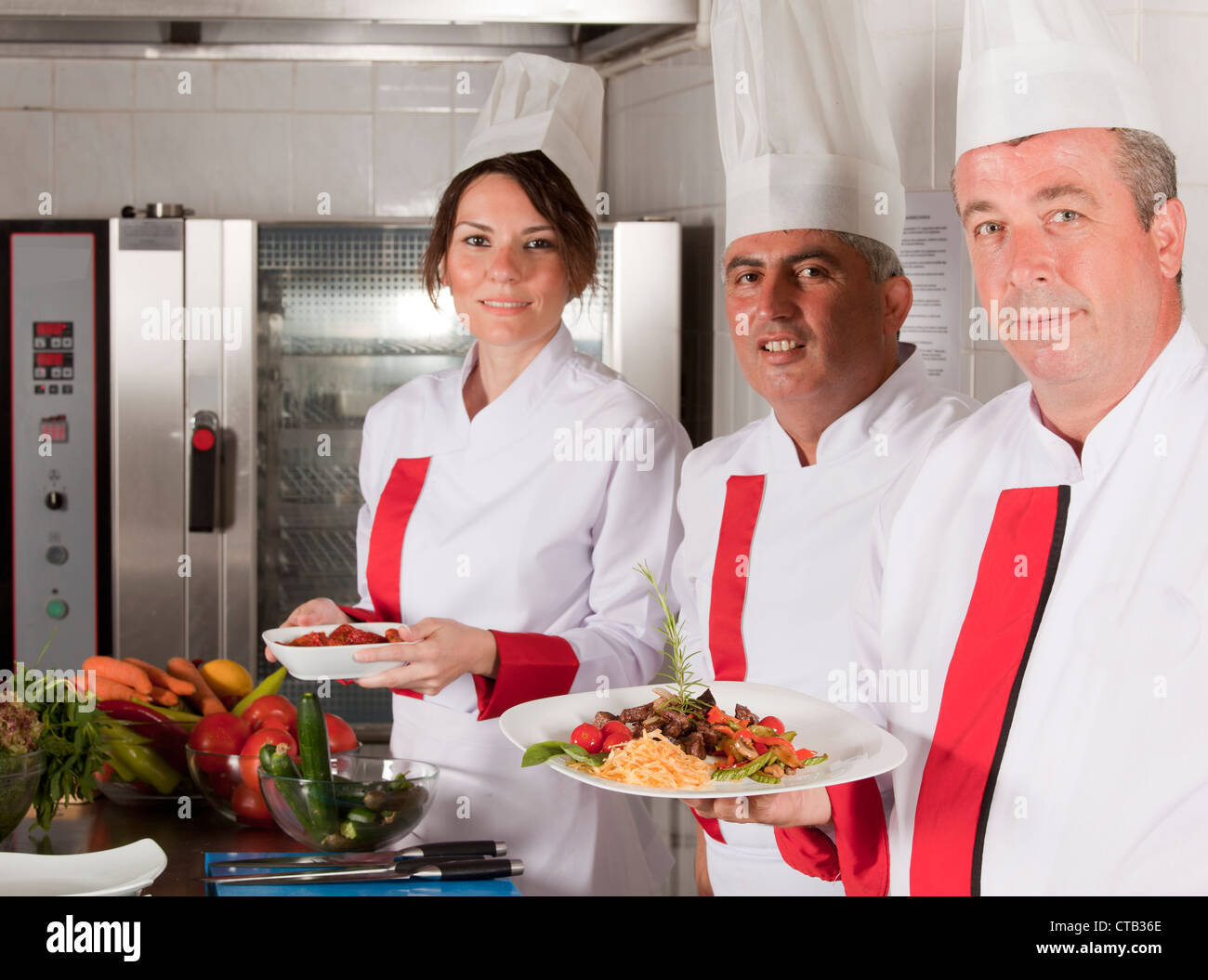 group of young beautiful professional chefs portrait in industrial ...