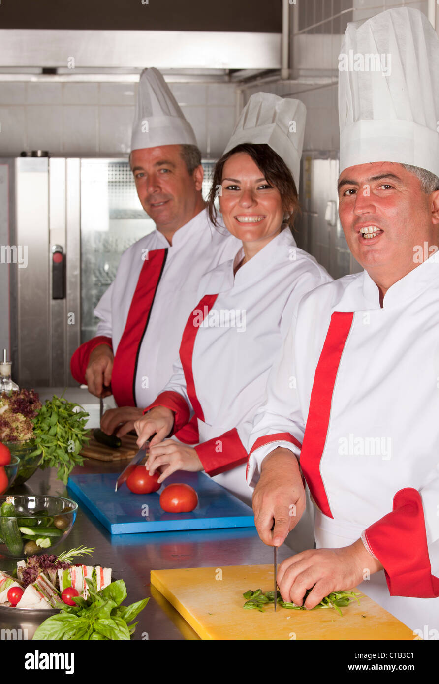 group of young beautiful professional chefs portrait in industrial ...