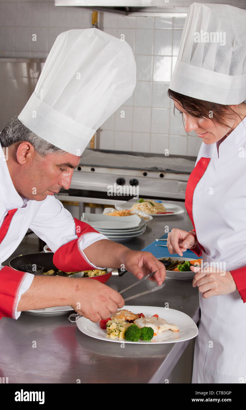 Two chefs at work in a restaurant Stock Photo - Alamy