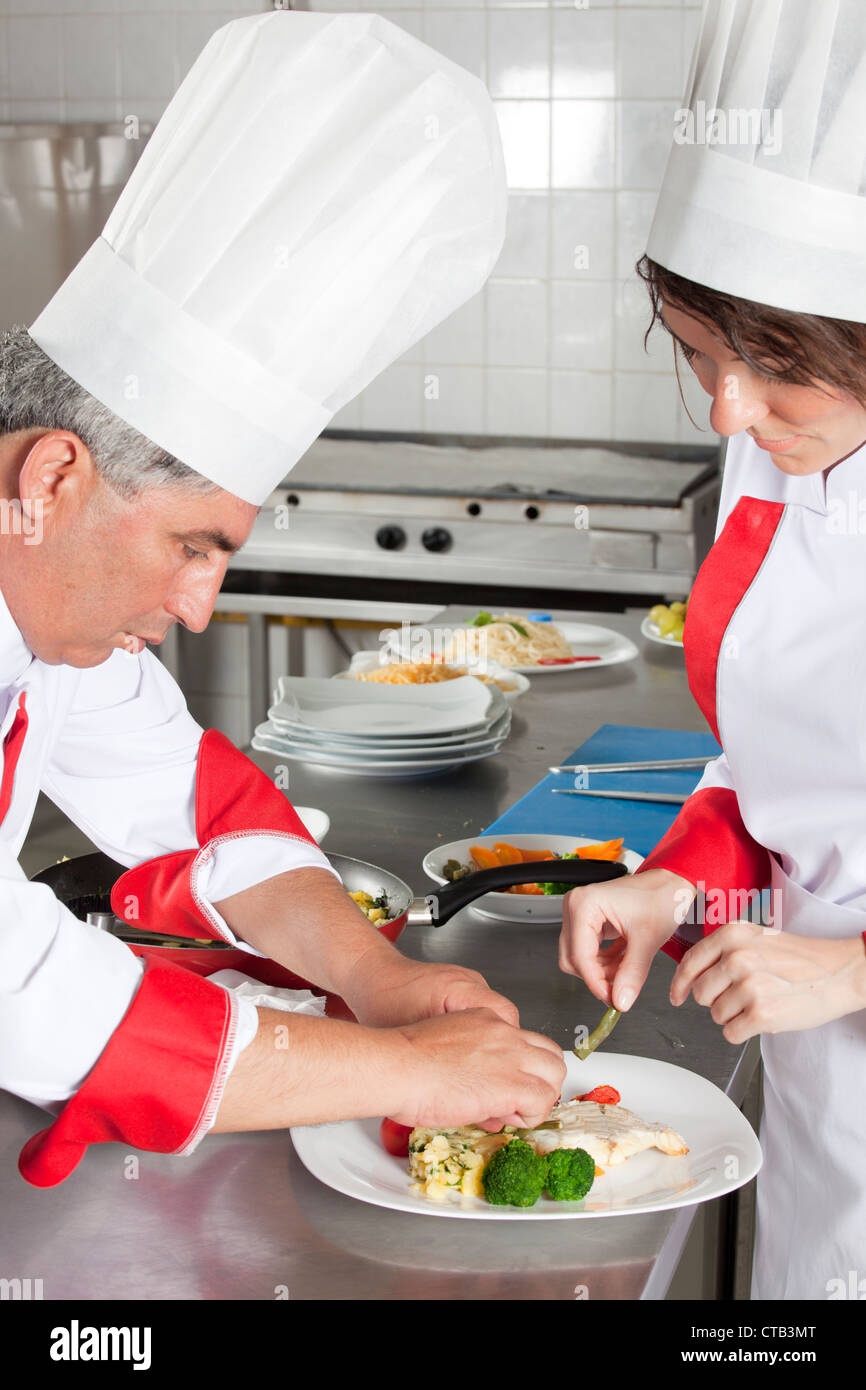 Two chefs at work in a restaurant Stock Photo - Alamy
