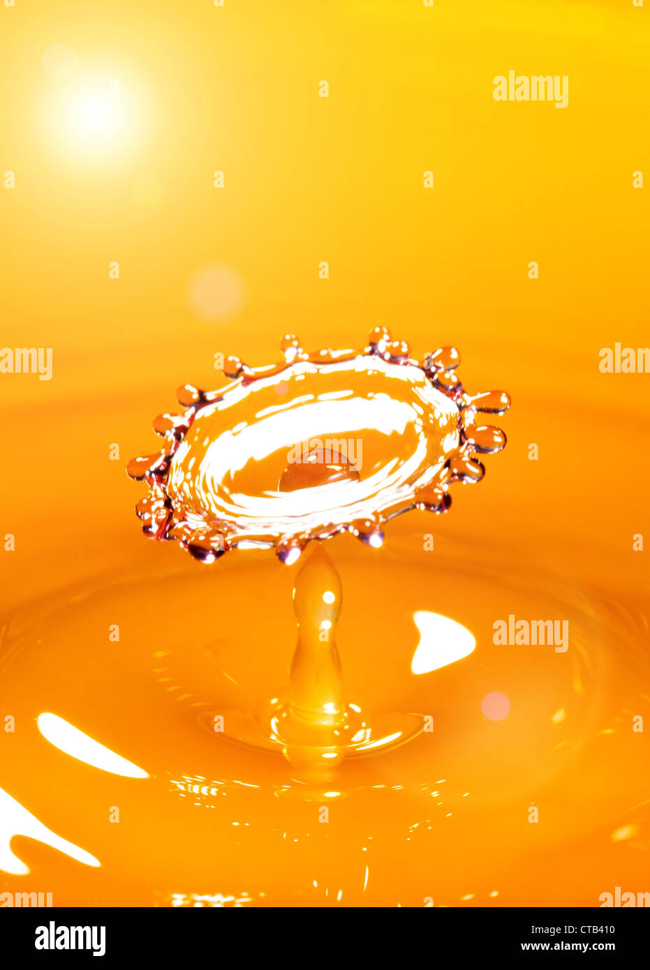 Drop of orange juice close up Stock Photo - Alamy