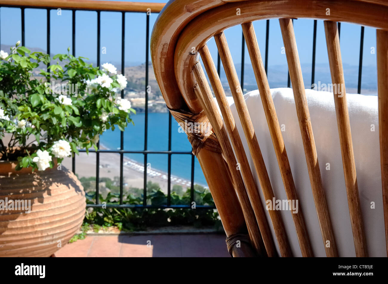 Back of chair in the bar of a luxury hotel, bright sun, see view in ...