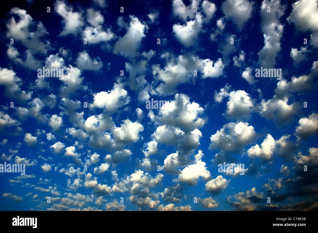 Early morning: blue sky with fluffy clouds Stock Photo - Alamy