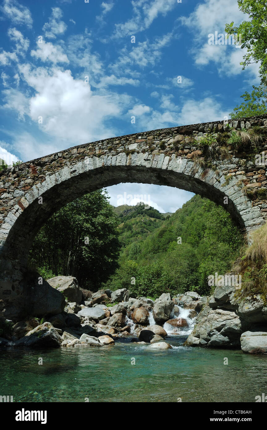 Aged arch bridge over a small mountain river Stock Photo - Alamy