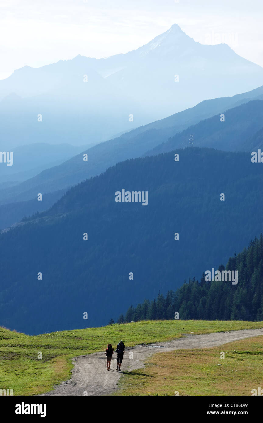 Trekkers walking along a mountain path,Mont Blanc valley, west Alps ...