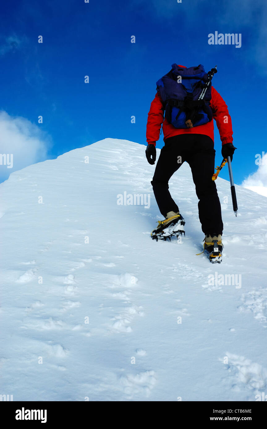 A lonely climber reaching the summit of the mountain Stock Photo - Alamy