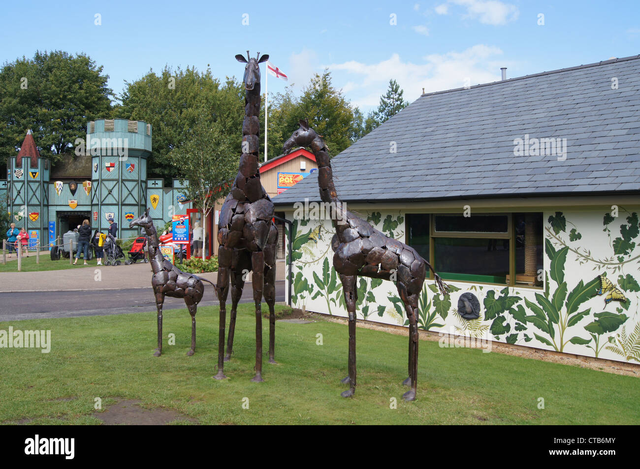 A group of three model metal Giraffes outside the souvenir shop at ...
