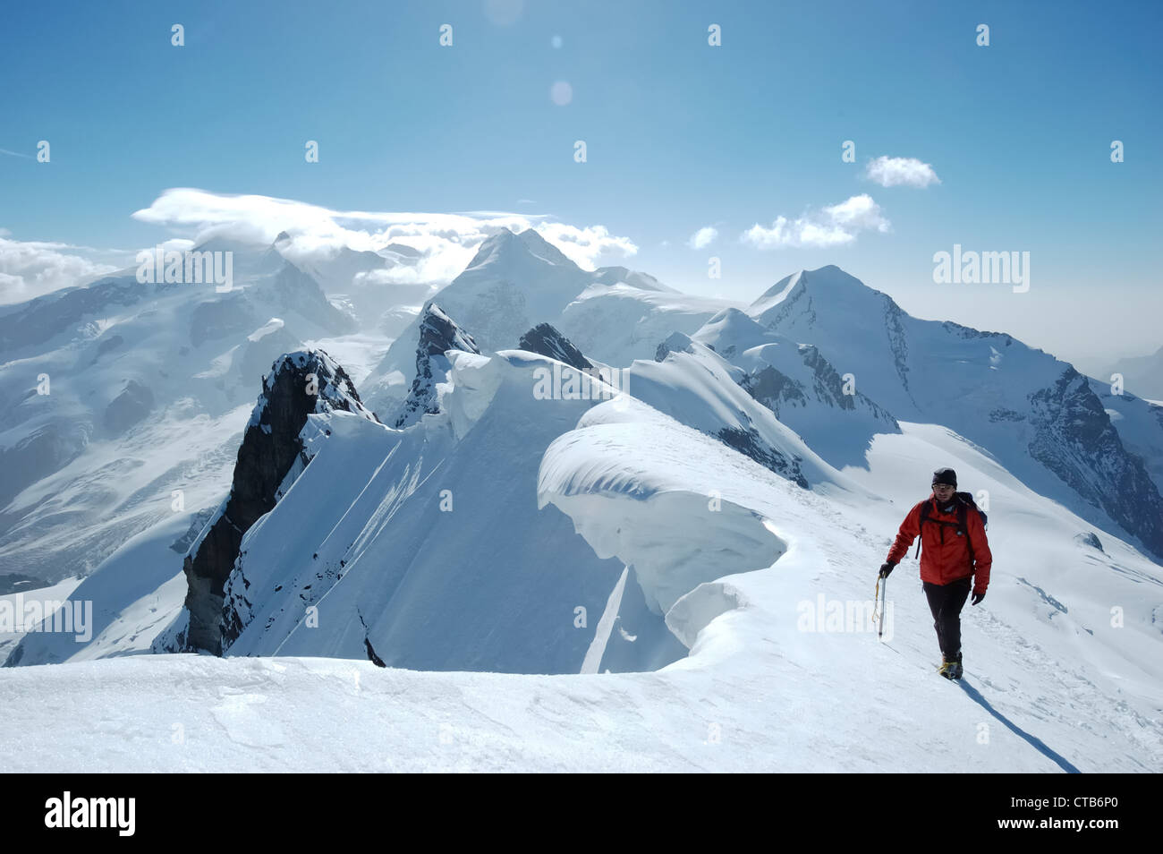 Climber on background the peaks and glaciers of Monte Rosa massif, west ...