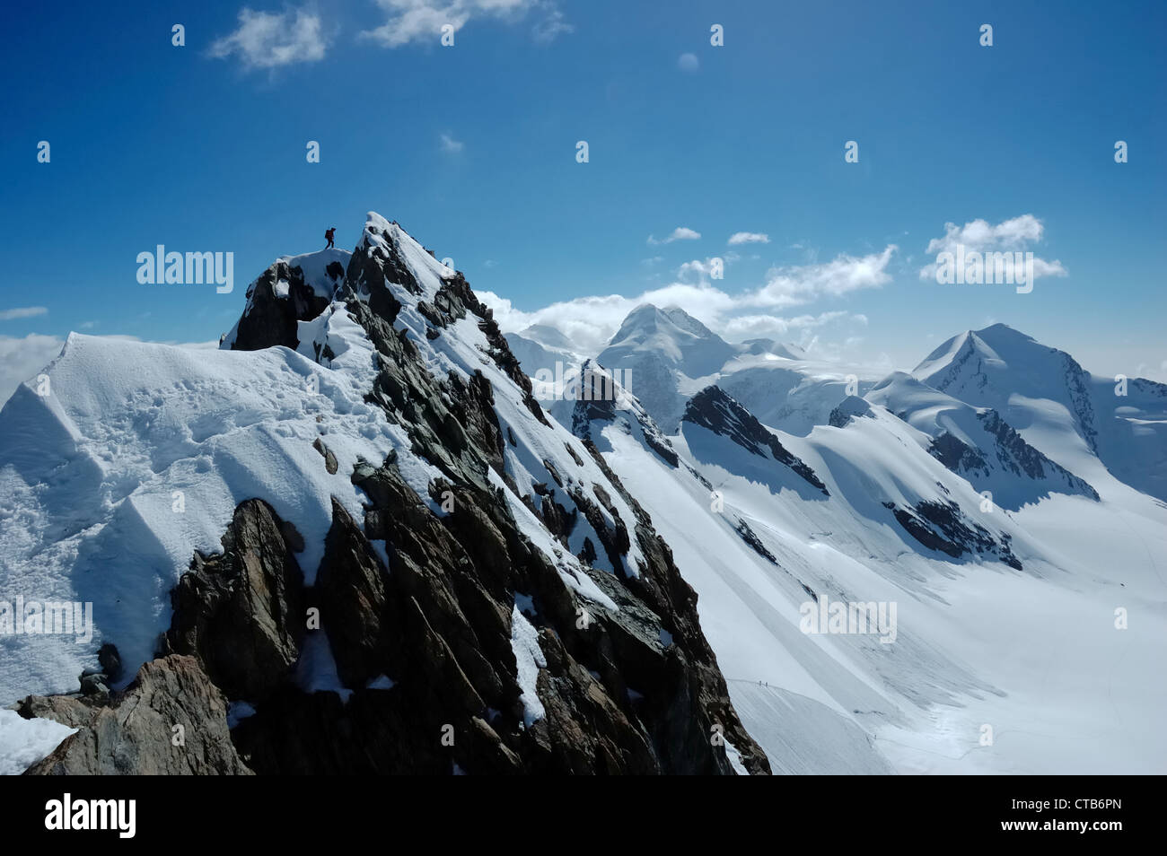 Climbers, on background the peaks and glaciers of Monte Rosa massif ...