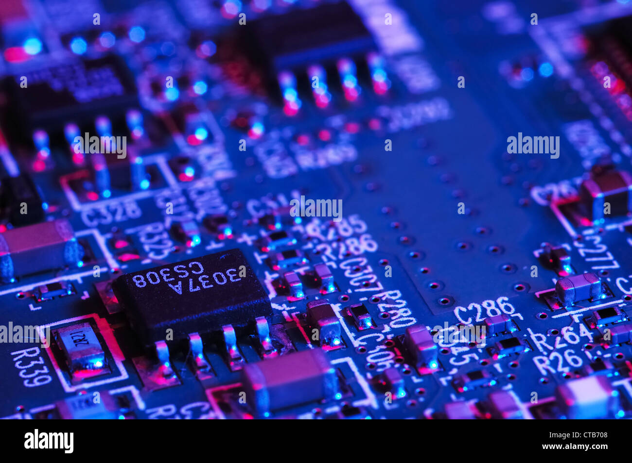 Close-up photo of computer circuit board; blue red tone Stock Photo - Alamy