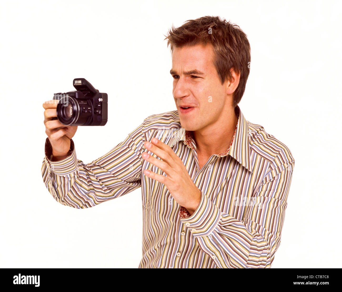 Young good looking white man with a digital camera, showing various ...