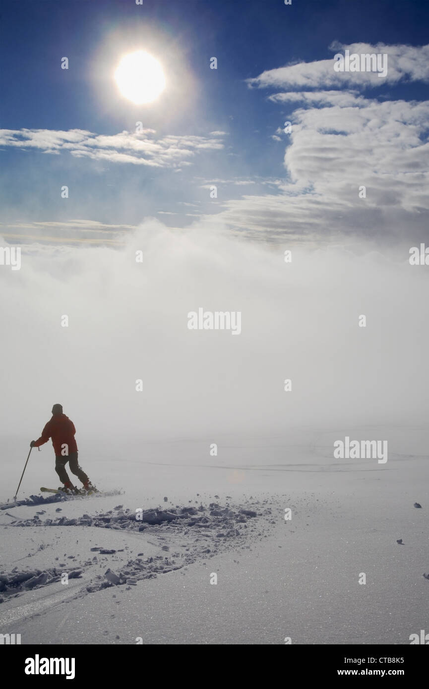 Young male skier on a ski slope; back view Stock Photo - Alamy