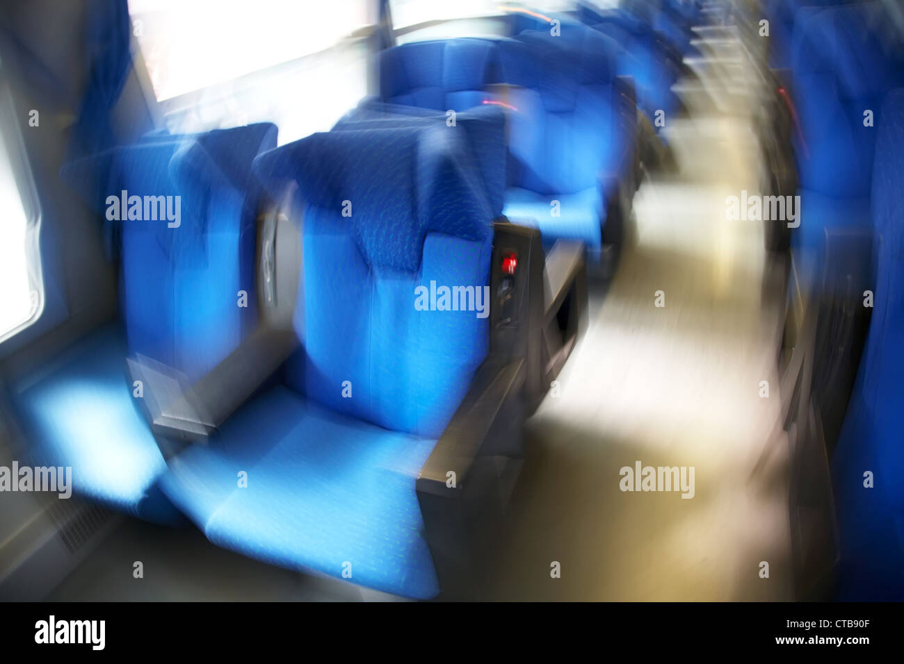 Vacant seats inside an empty passenger train. Horizontal frame. Blur ...