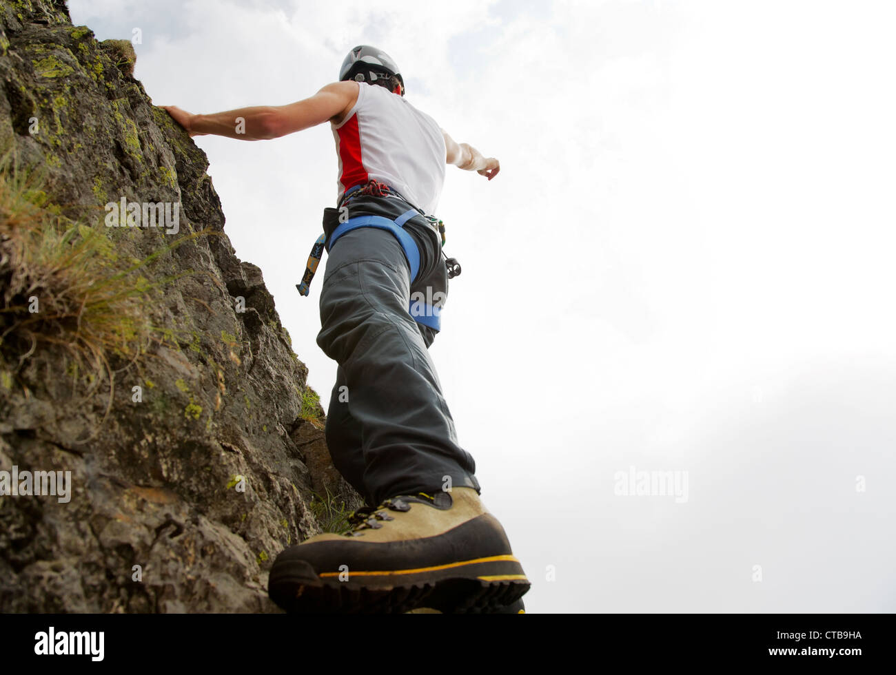 White young male rock-climber summer season upward view horizontal ...