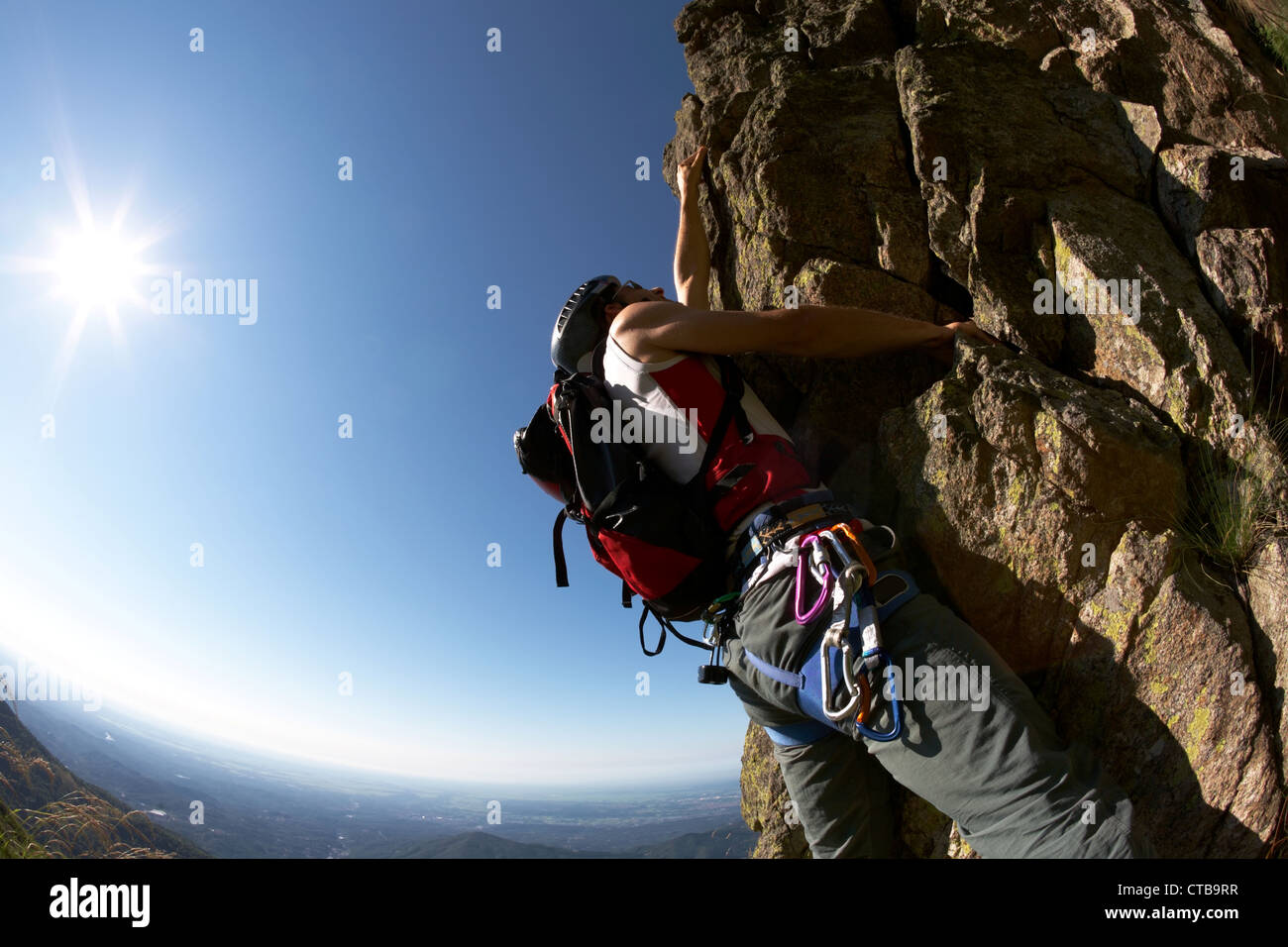Climber climbing a rocky wall; horizontal frame Stock Photo - Alamy