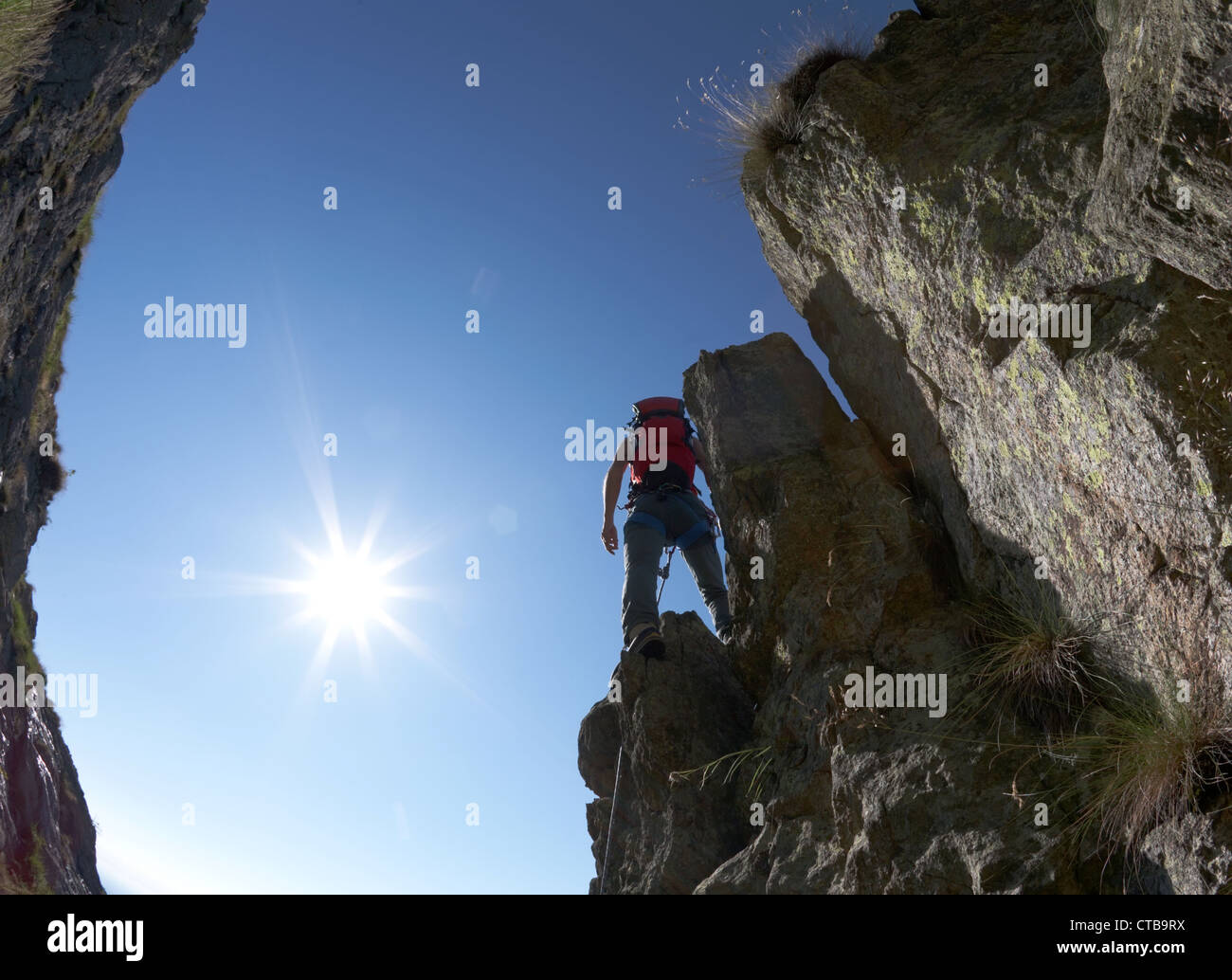 Terrific view of a climbing route: climber standing on the rocky ridge ...