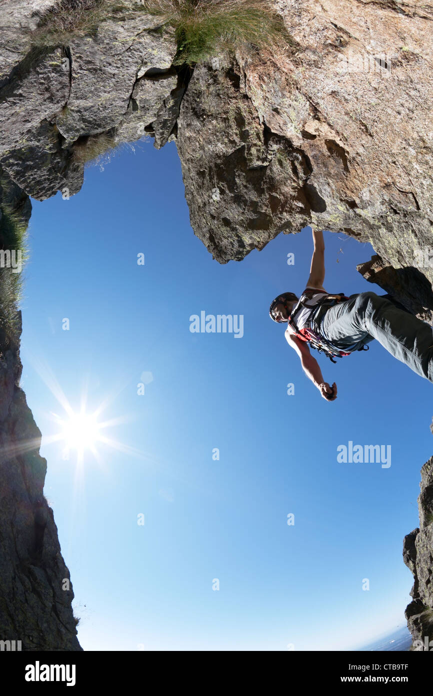 Terrific view of a climbing route: young man climbing a rocky ridge ...