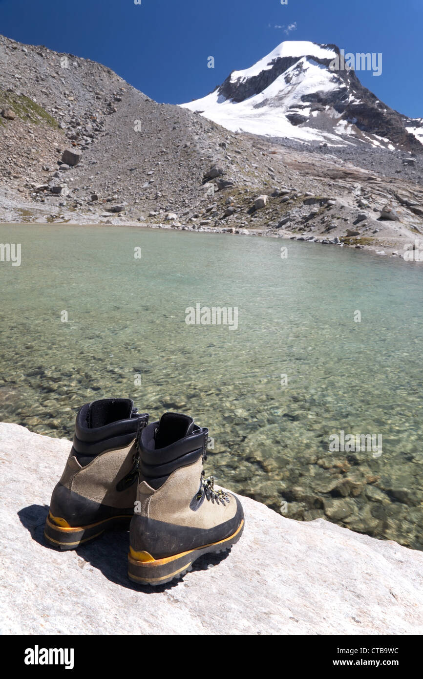Hiking boots, back view, in background mountain landscape with lake and ...