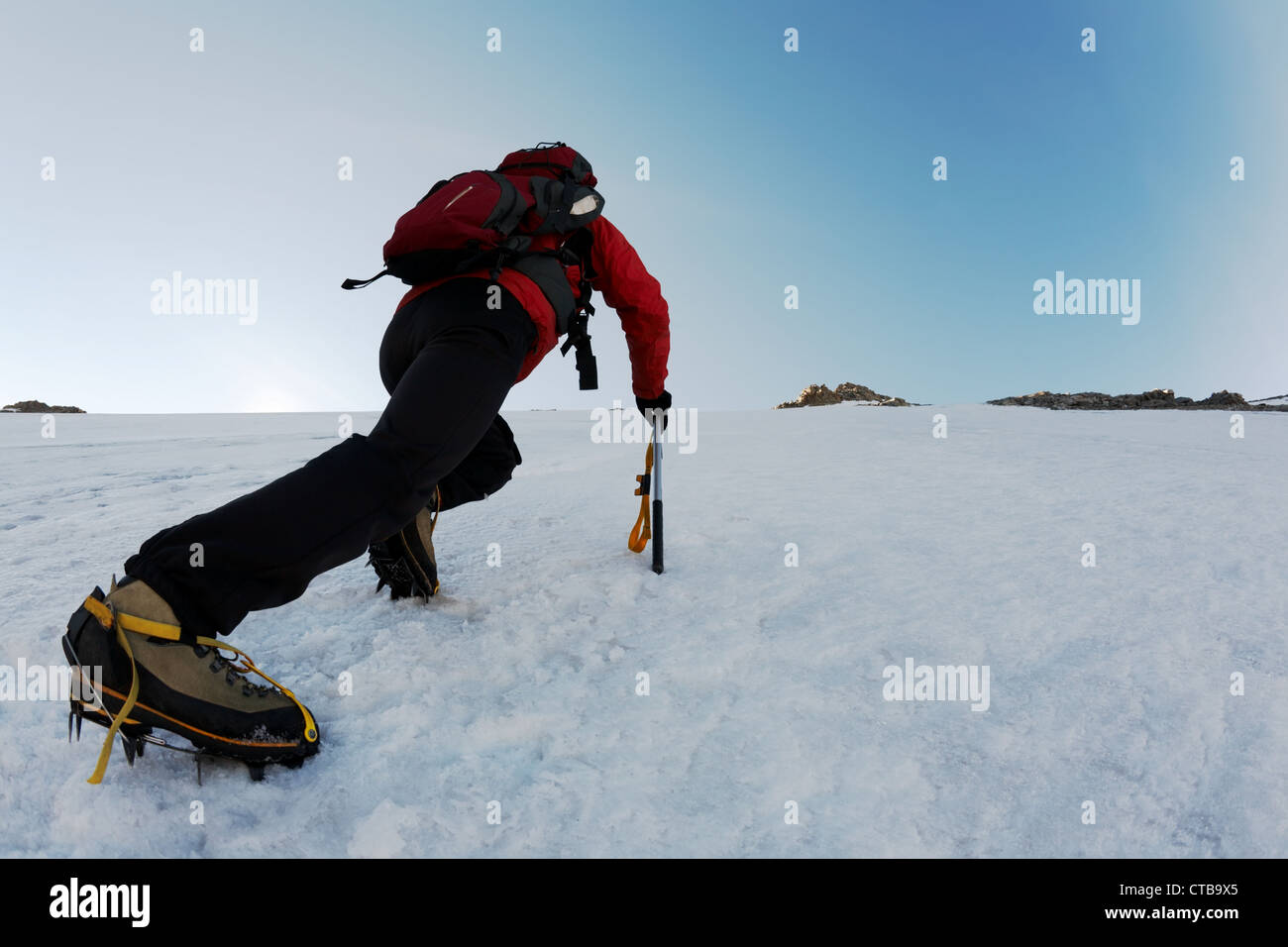 Mountaineer climbing a steep route on a icy slope, italian Alps, Europe ...