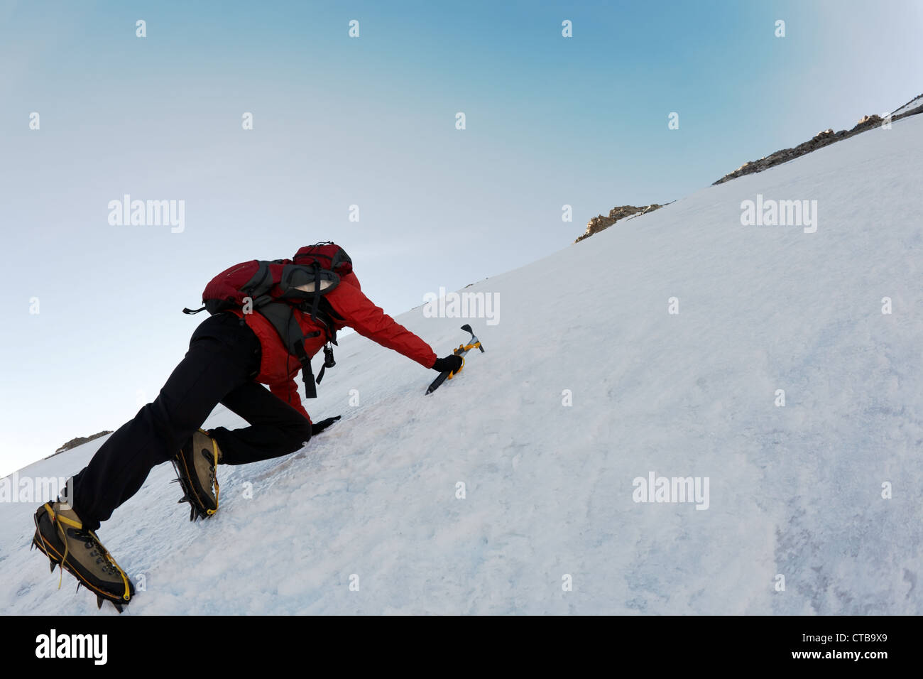 Mountaineer climbing a steep route on a icy slope, italian Alps, Europe ...